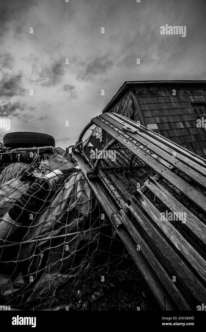 Vertical shot of a damaged wooden cage in a field in grayscale Stock ...