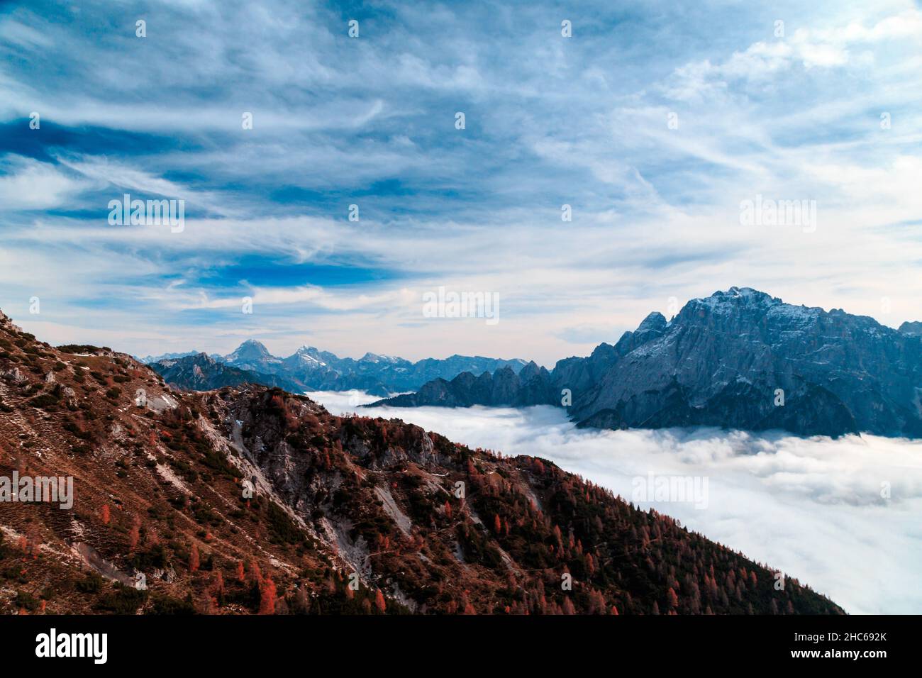 Clouds in the valley under the peak of Julian Alps Stock Photo - Alamy