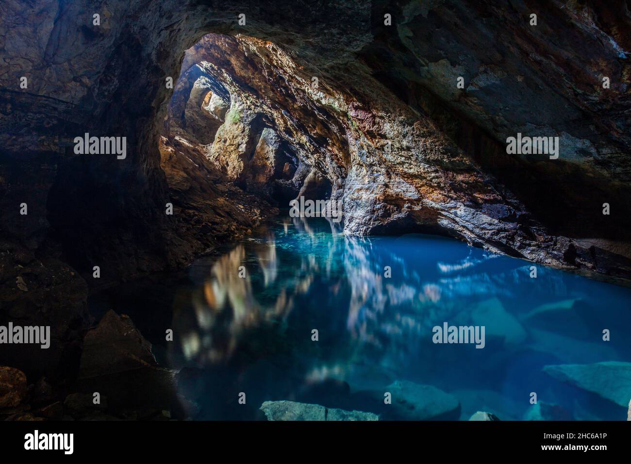 Long exposure shot of azure water flowing into the cave Stock Photo - Alamy