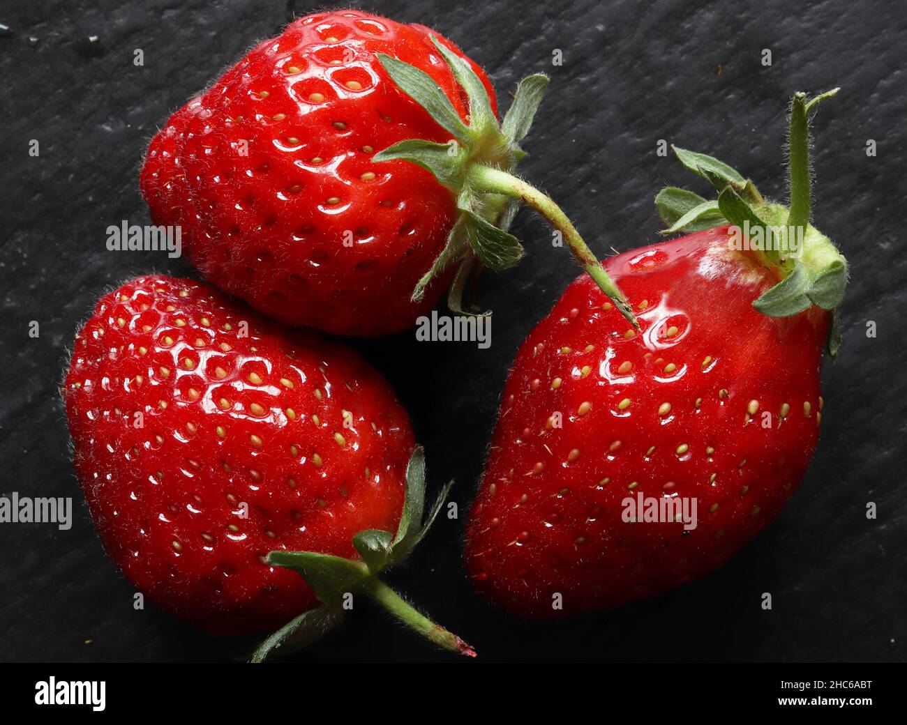 Photography of three strawberries on slate for food background Stock ...
