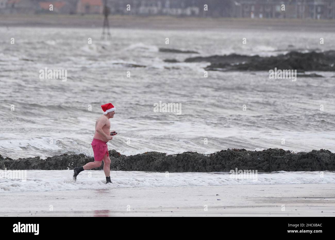 A swimmer in a santa hat takes a Christmas Day dip at Portobello Beach ...