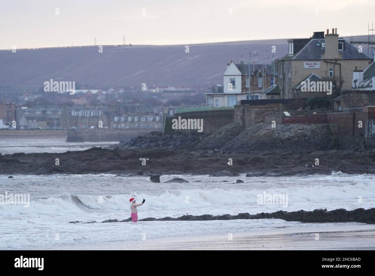 A swimmer in a santa hat takes a Christmas Day dip at Portobello Beach ...