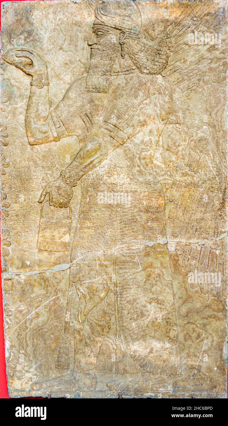 Assyrian wall relief of a winged genius. Ancient carving panel from the ...