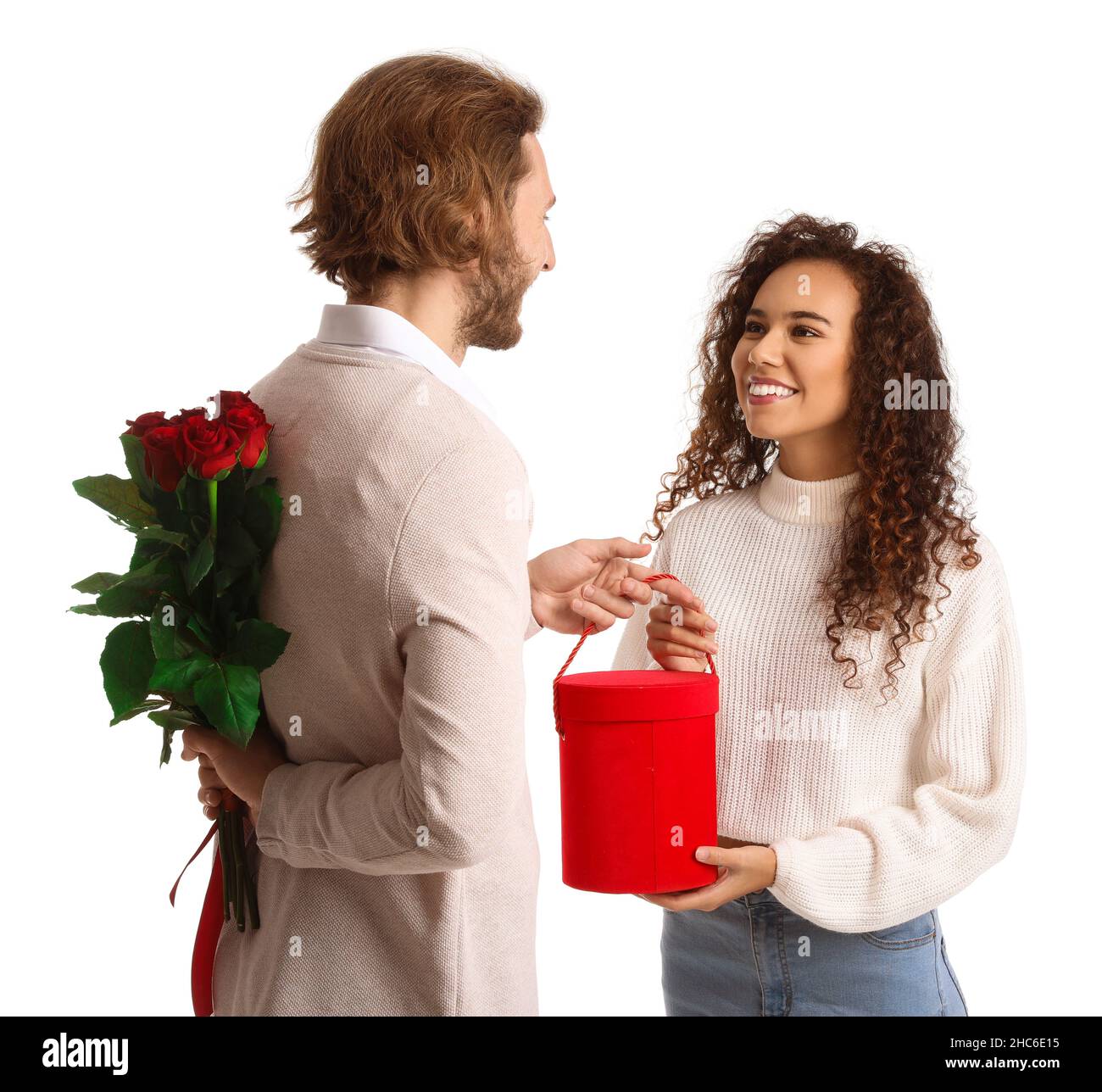 Happy young couple greeting each other on Valentine's Day against white ...