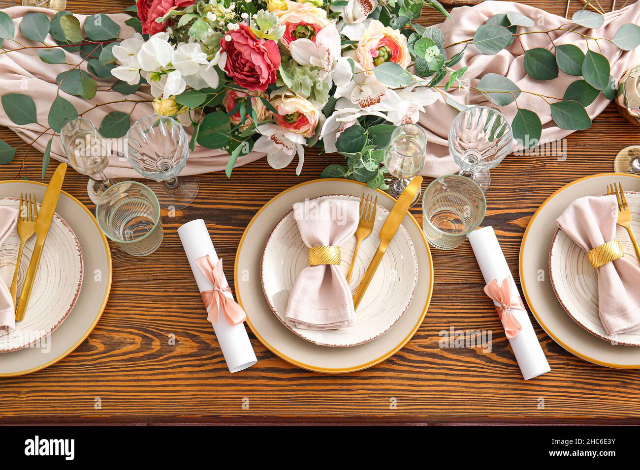 Beautiful table setting with wedding invitations on wooden background ...
