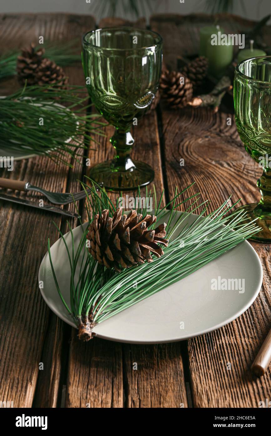 Beautiful table setting with pine cones and fir branches Stock Photo ...