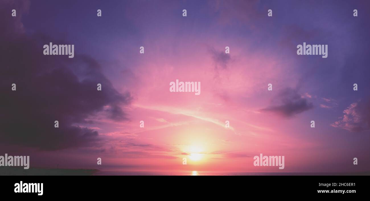 Horizontal panorama of a dramatic glowing cloudy sky at sunset. Sky ...