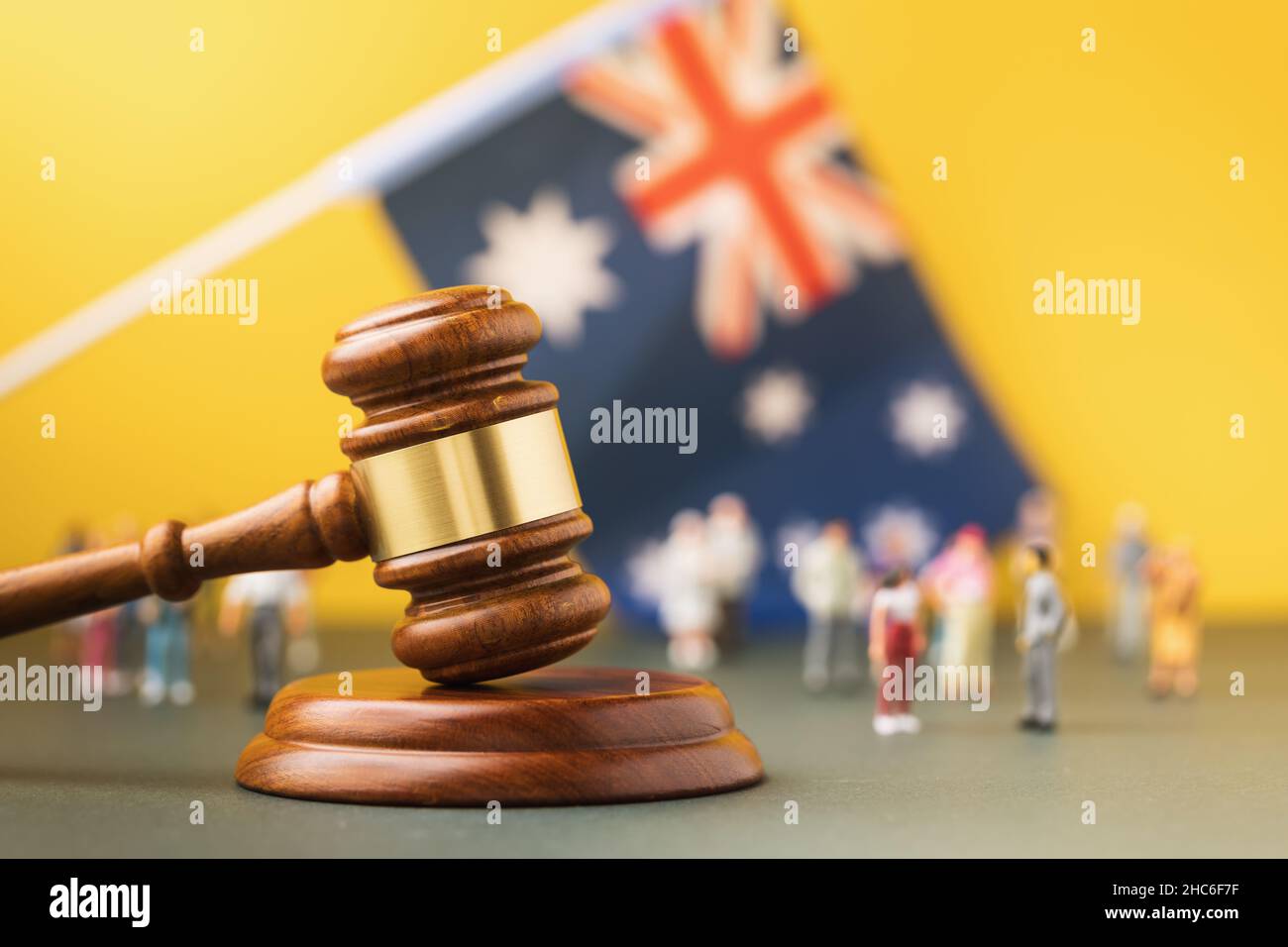 Judge gavel against a blurred Australian flag and plastic toy men ...