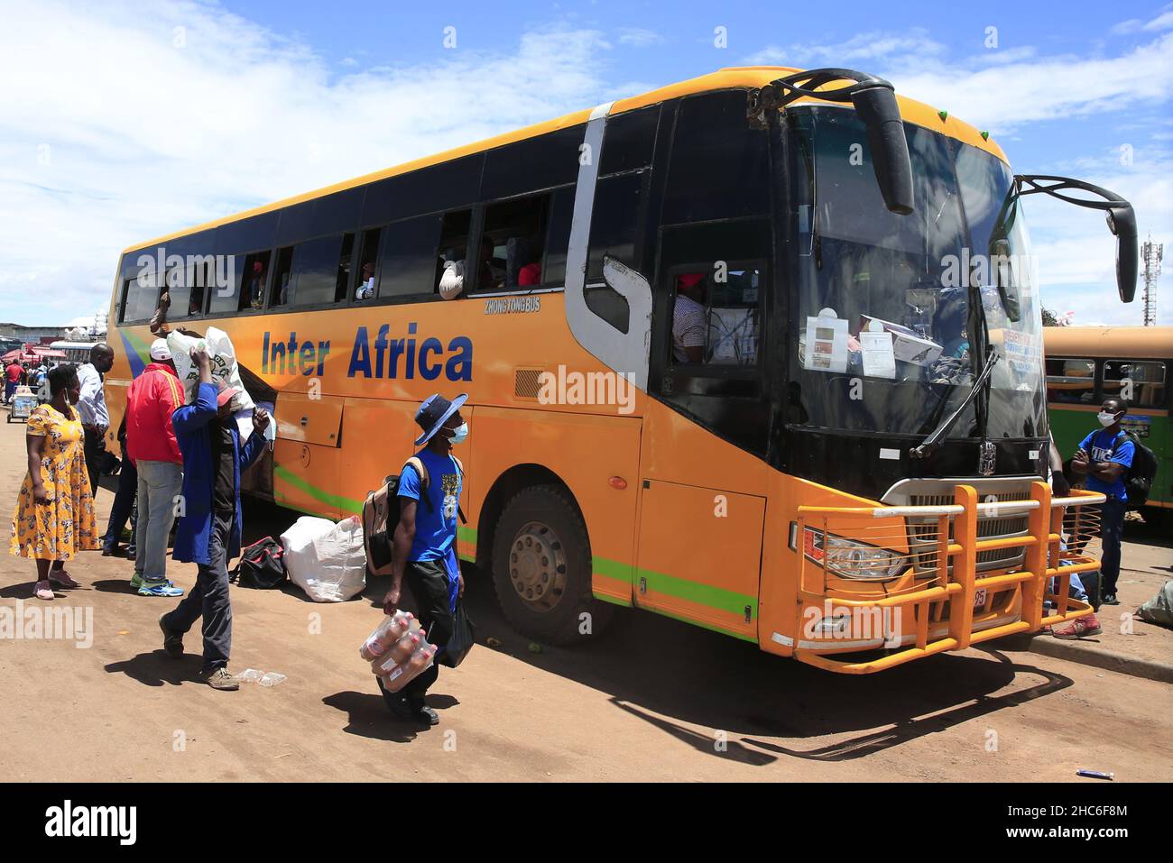 Harare, Zimbabwe. 23rd Dec, 2021. People prepare to board a bus at Mbare Musika bus terminus in ...