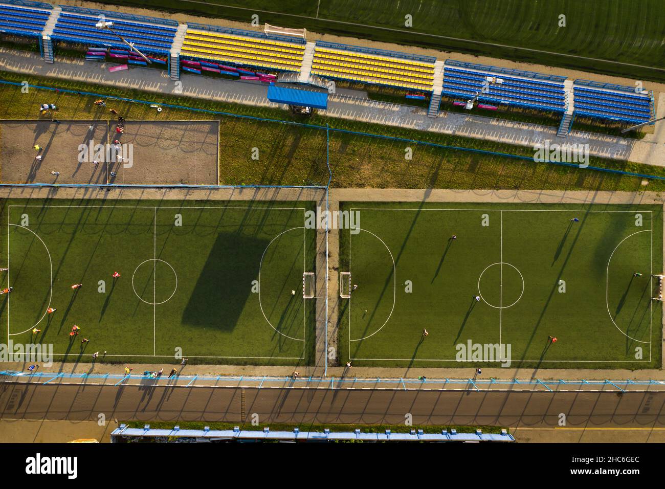 Top view of a sports football field with players playing football.a ...