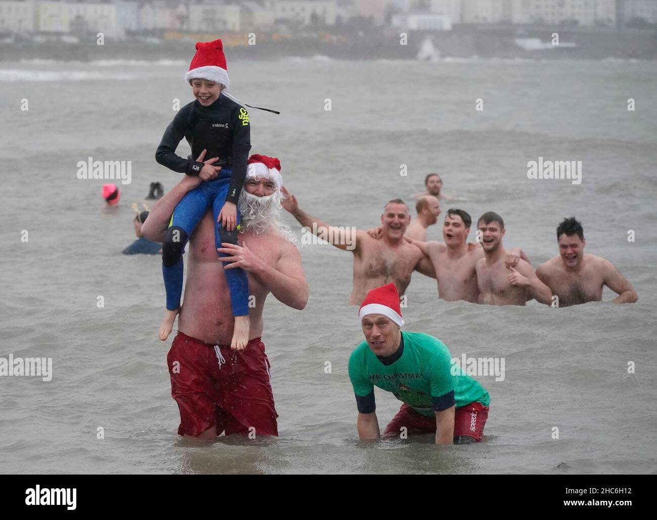 Patrick Corkery lifts his son Matthew (10) during a Christmas Day dip ...