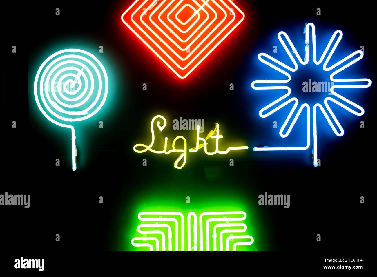 Illuminated letters written light on dark black background. Neon ...