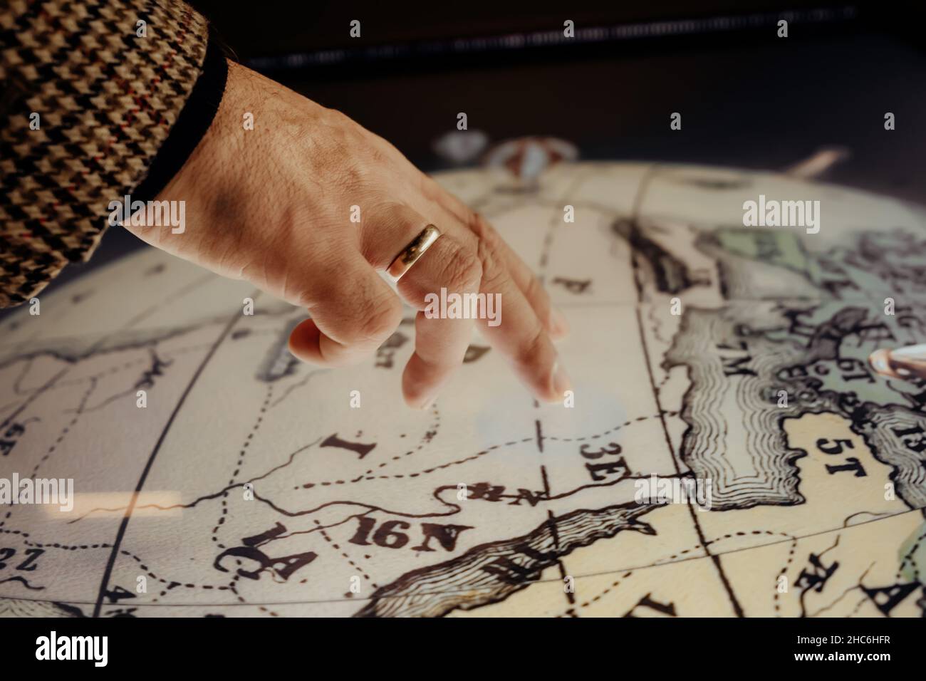 Male hand tapping on globe. Our planet, world map, geography education ...