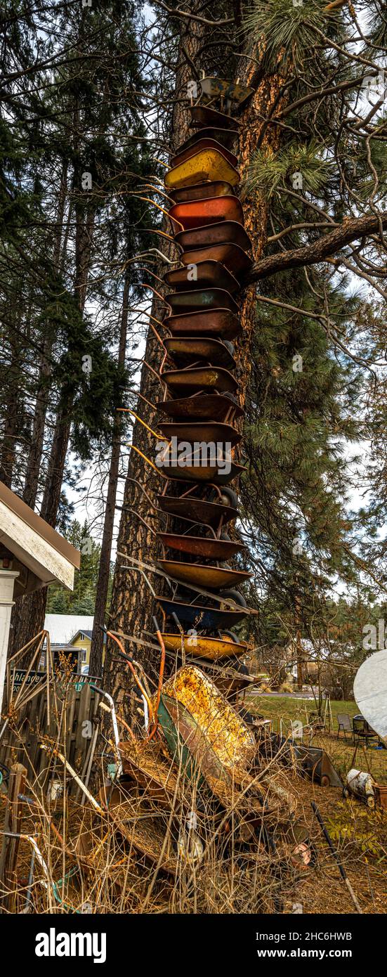 Stacked Old Wheelbarrows next to a Tree Stock Photo - Alamy