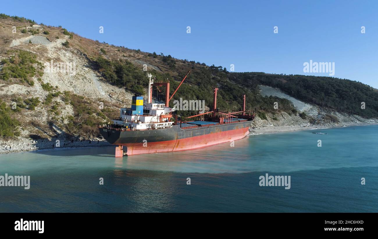 Sunny landscape with moored tanker vessel ship near the slope covered ...
