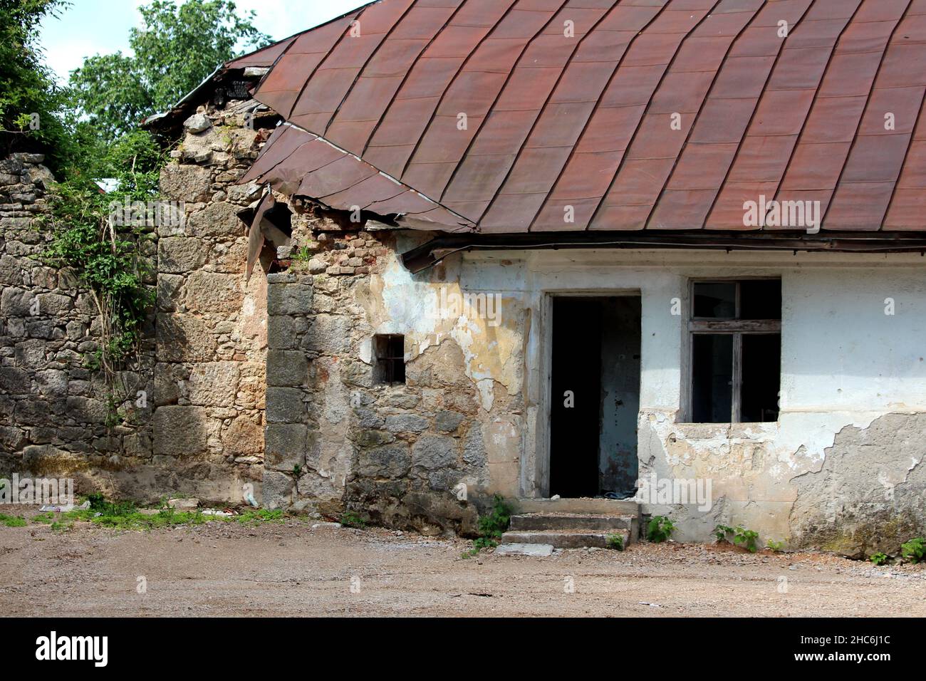 Abandoned old traditional stone house with missing doors and broken ...