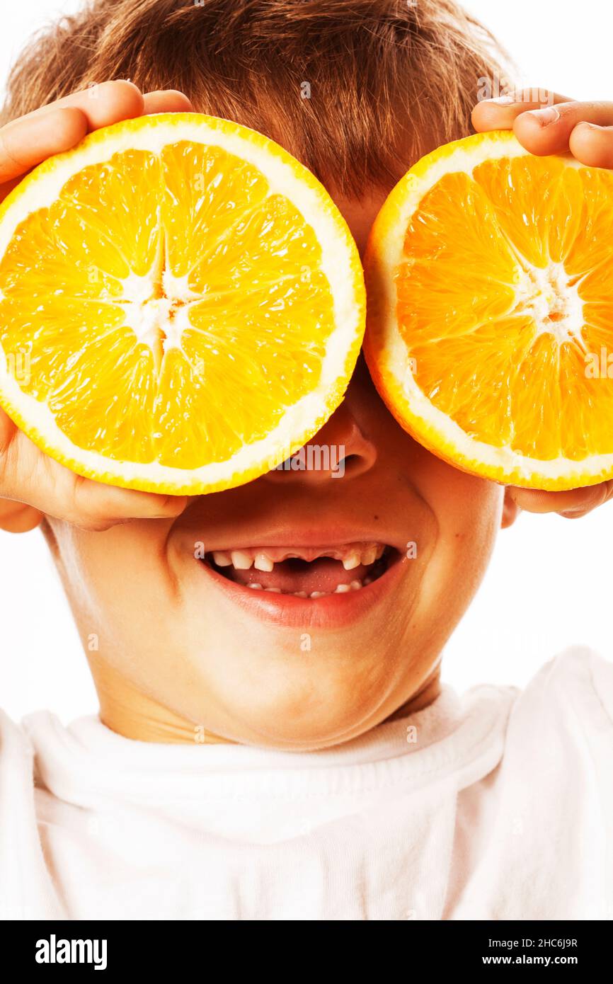 little cute boy with orange fruit double isolated on white smiling ...