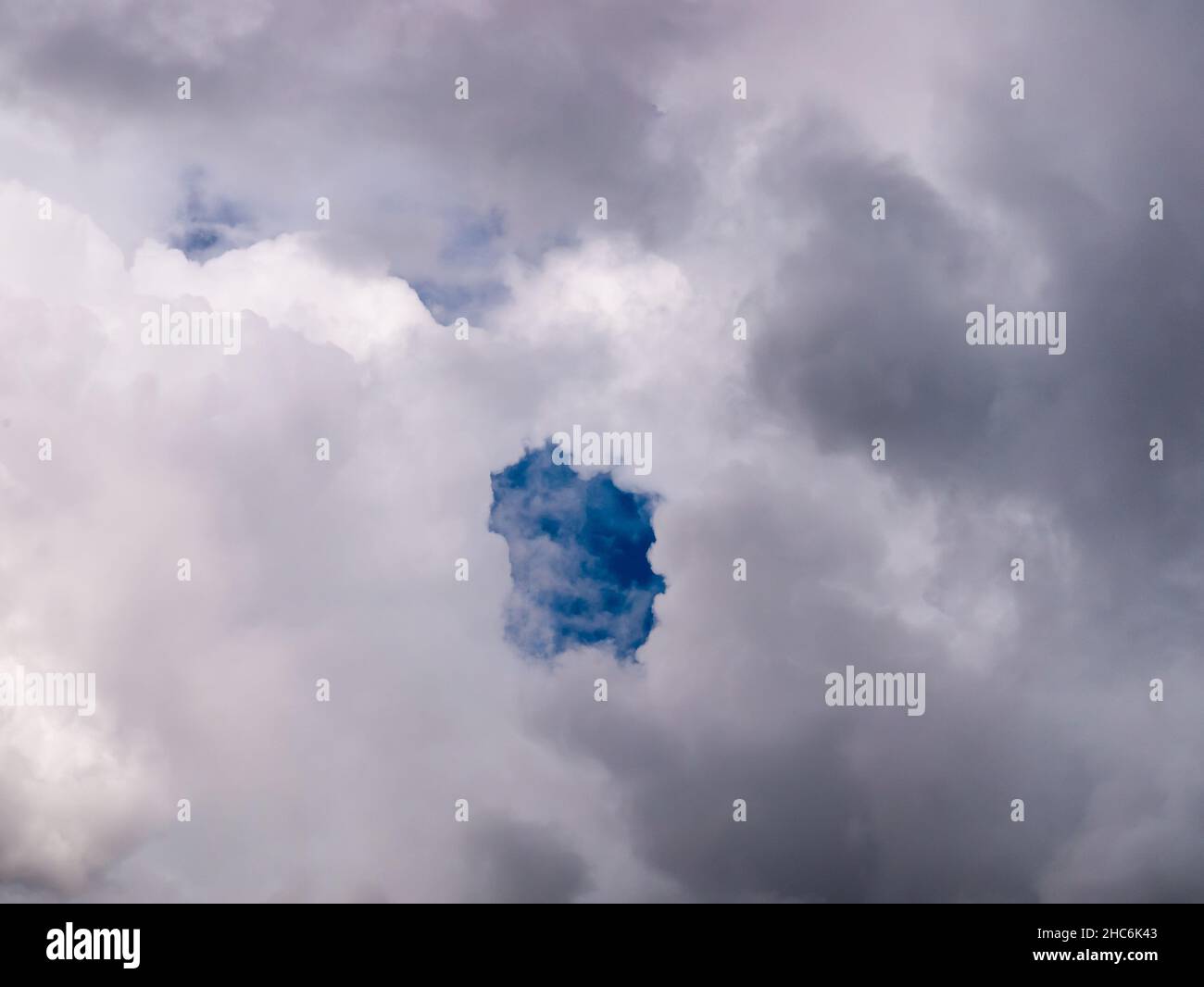 Square hole in thick clouds Stock Photo - Alamy