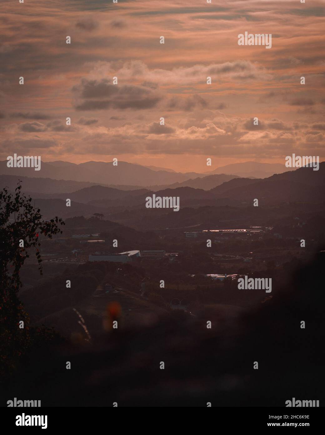 Vertical aerial view of a country and mountains on the background at ...