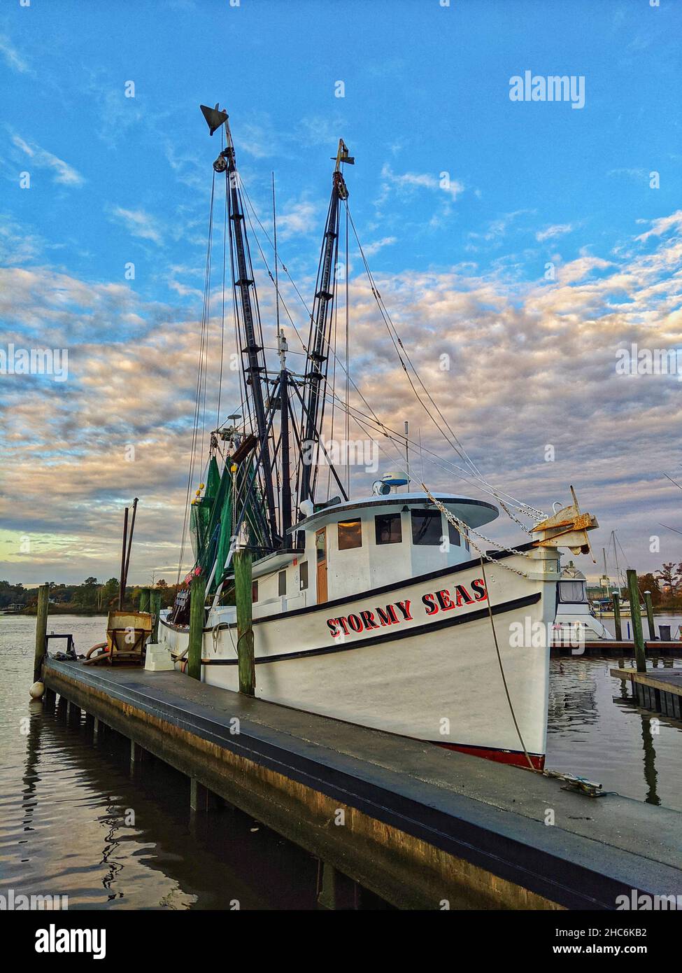 Vertical shot of a shrimp boat of "Stormy Seas" in the dock of ...