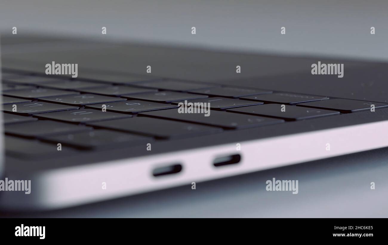 Close up side view of a new laptop with black keyboard on white ...