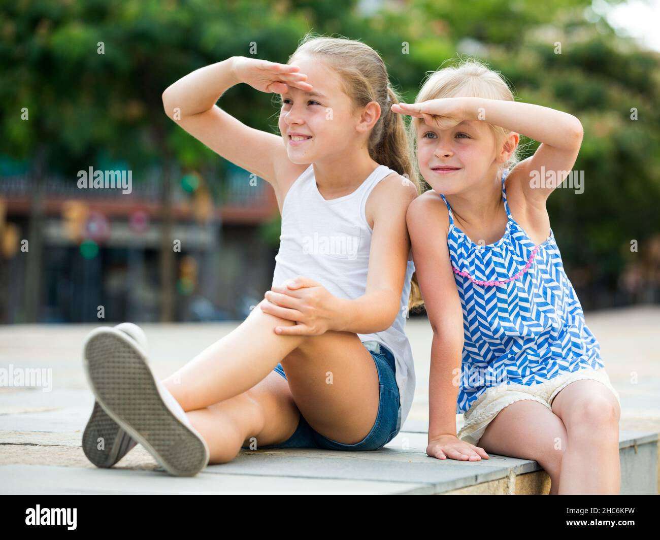 Two small sisters looking into distance Stock Photo - Alamy