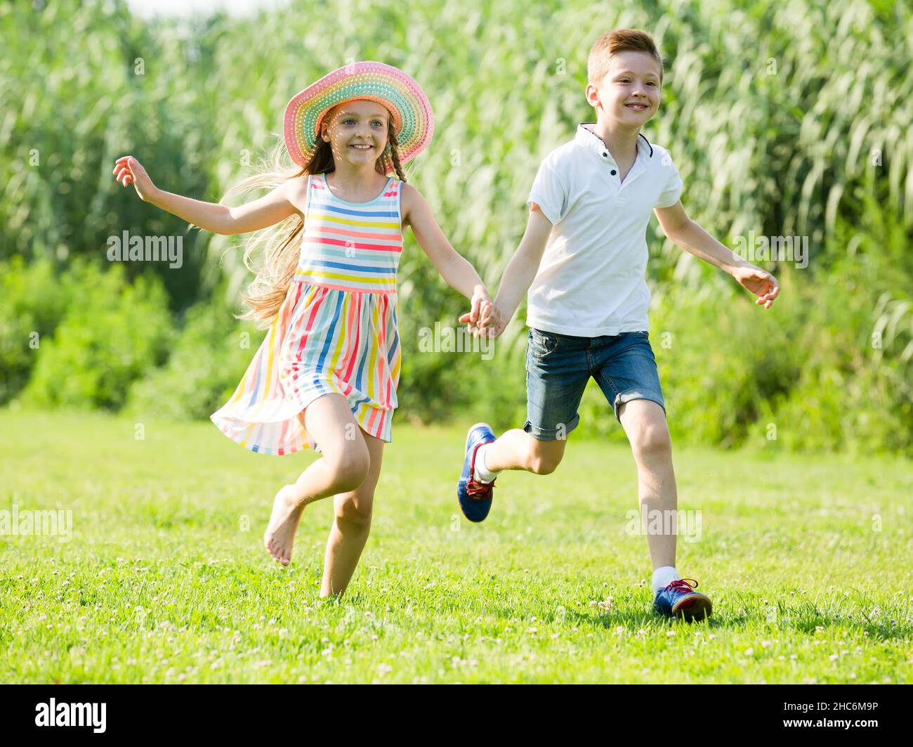 Two children running in park Stock Photo - Alamy