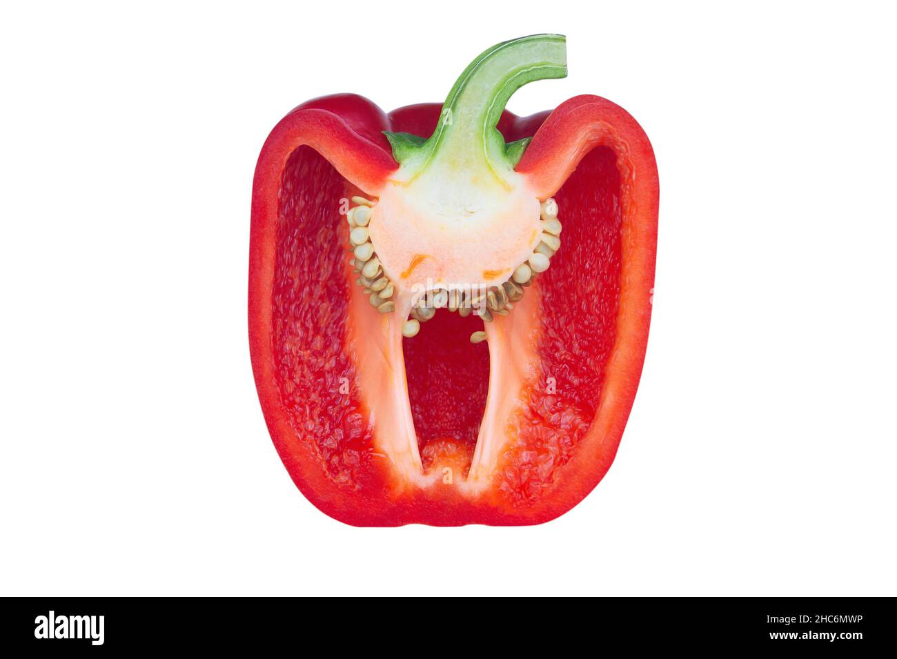 A close-up of bright red bell pepper and cut in half vertically on a ...