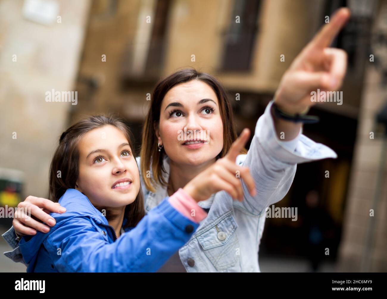 Mother and daughter pointing at sight during Stock Photo - Alamy
