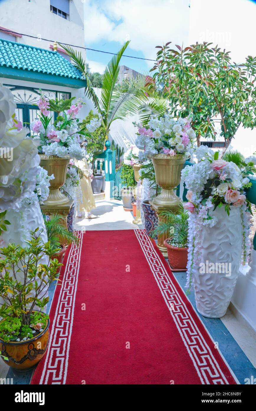Moroccan wedding corridor with roses as decoration and carpet where the ...