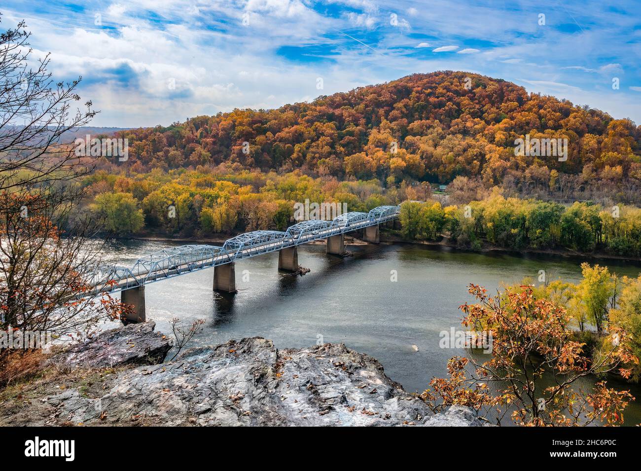 Bright autumn morning in the mountains with a bridge going over a clear ...