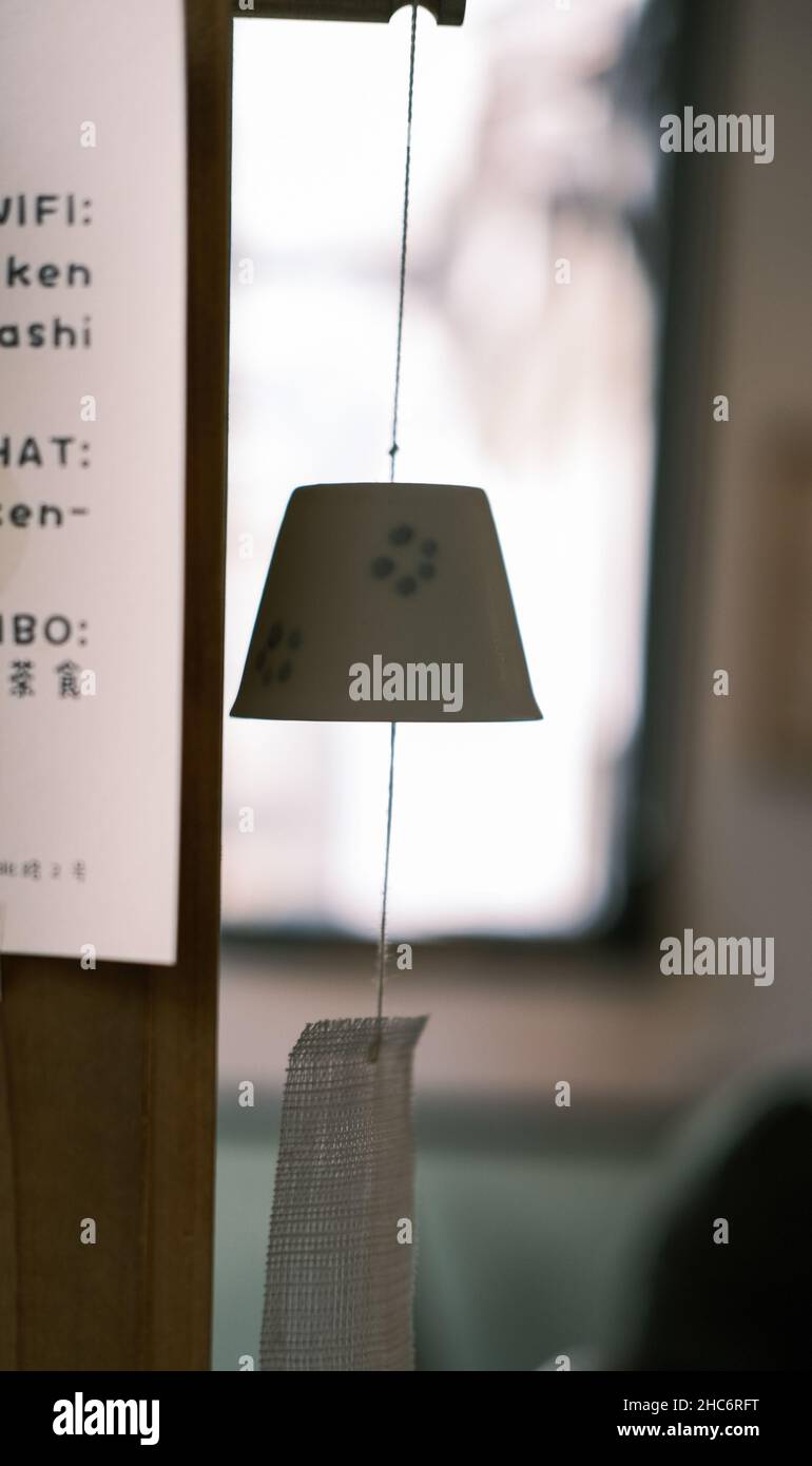 Wind chimes hanging by the window Stock Photo - Alamy