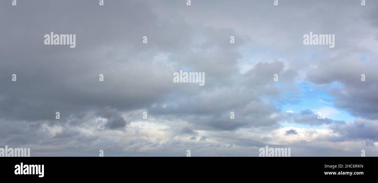 dramatic sky with a small window of blue sky Stock Photo - Alamy