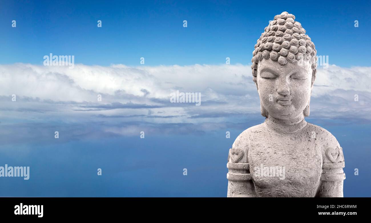 buddha's head on the background of a high blue sky with copy space ...