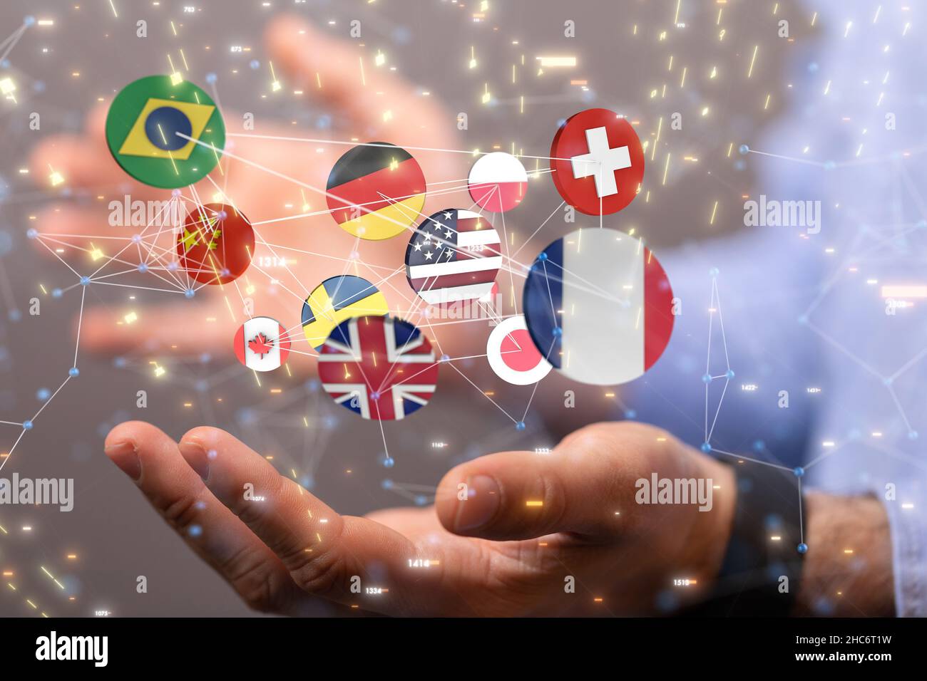 Male's hand holding illustrated bunch of different countries' flags ...