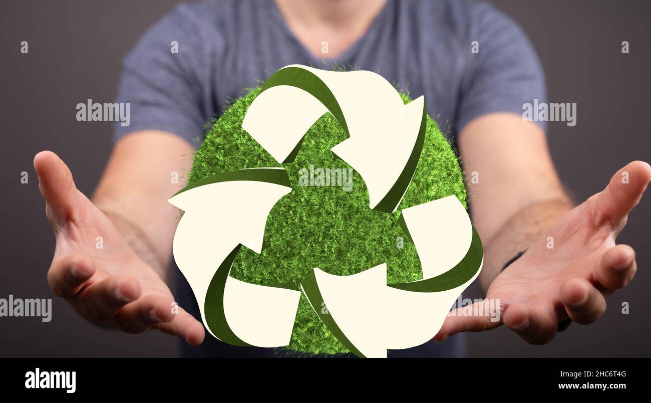 Male's hand holding an illustration of a recycling sign Stock Photo - Alamy