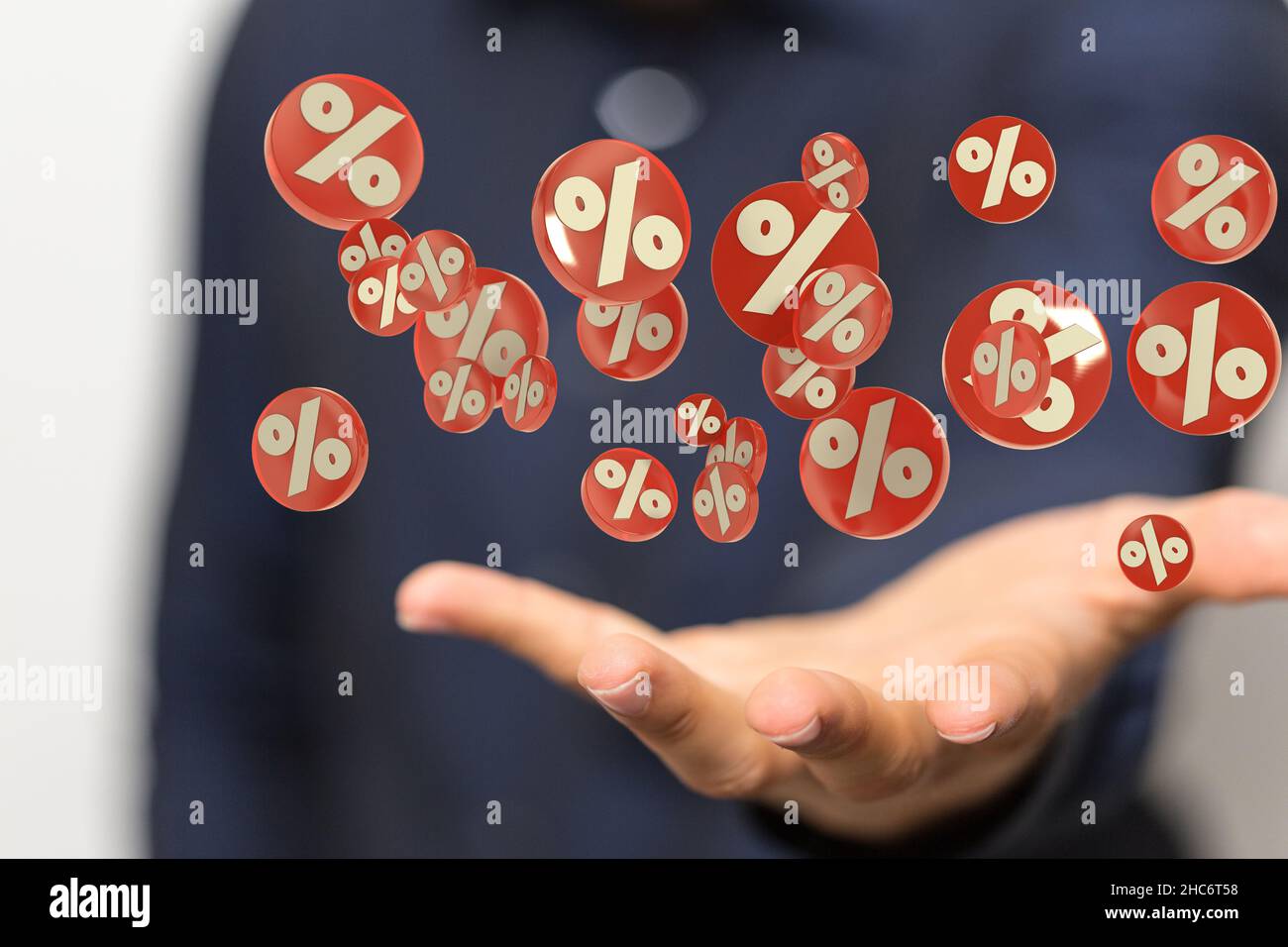 Male's hand holding an illustration of a bunch of red and white percent ...