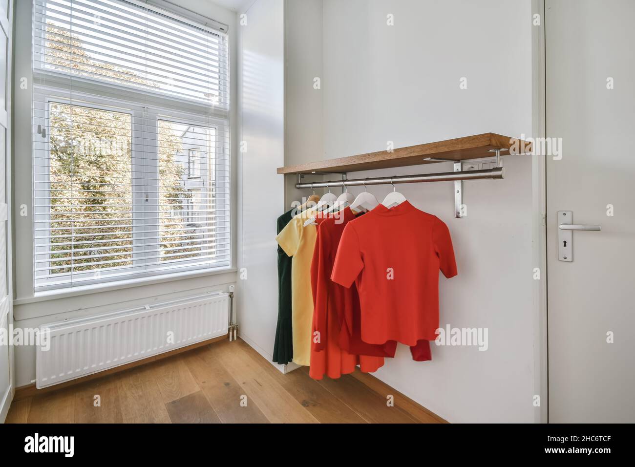 Dressing room with a window with hanging clothes Stock Photo - Alamy
