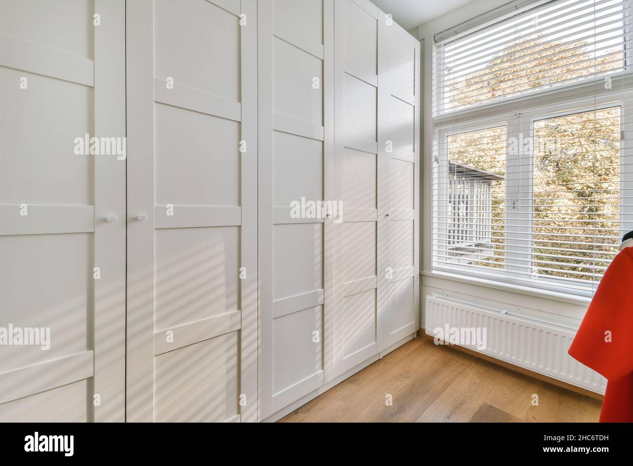 Dressing room with window with full wall wardrobe Stock Photo - Alamy