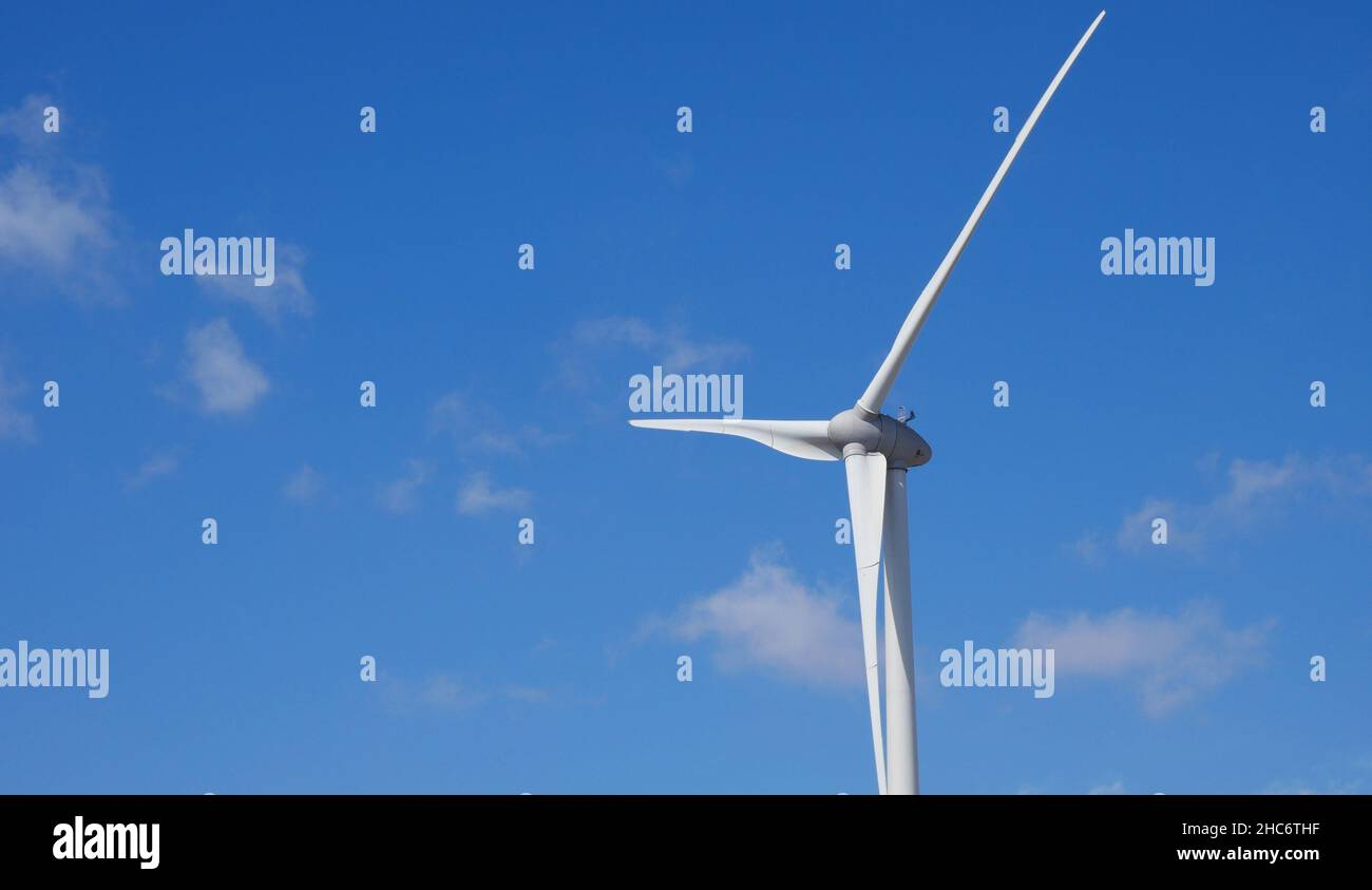 Closeup shot of a wind turbine on the background of heaven on a sunny ...