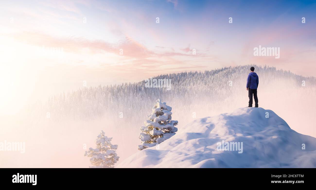 Adult adventurous man standing on top of a snow peak Stock Photo - Alamy