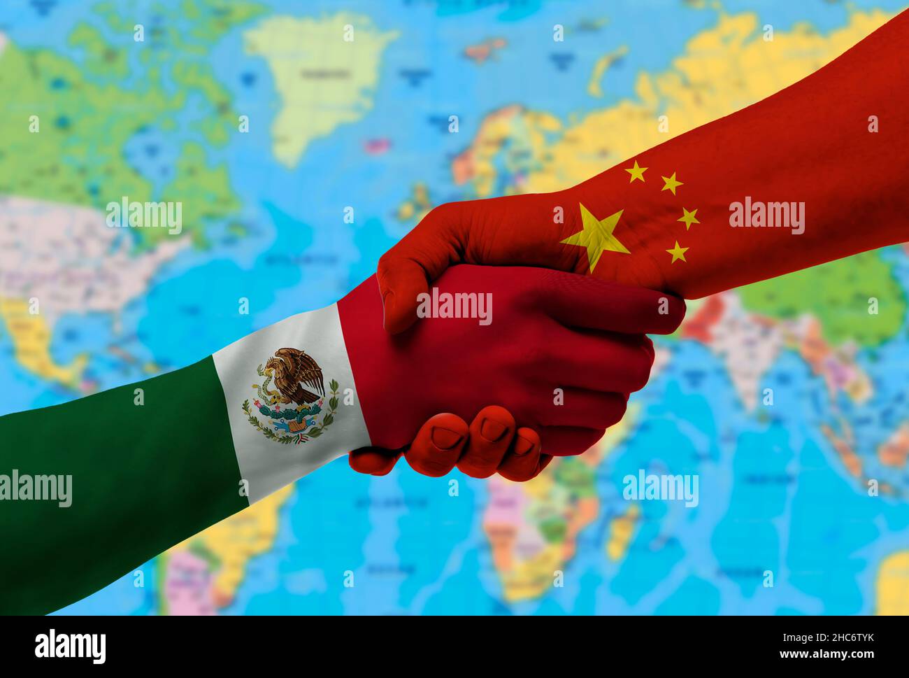 Handshake between Mexico and China flags painted on hands.With ...