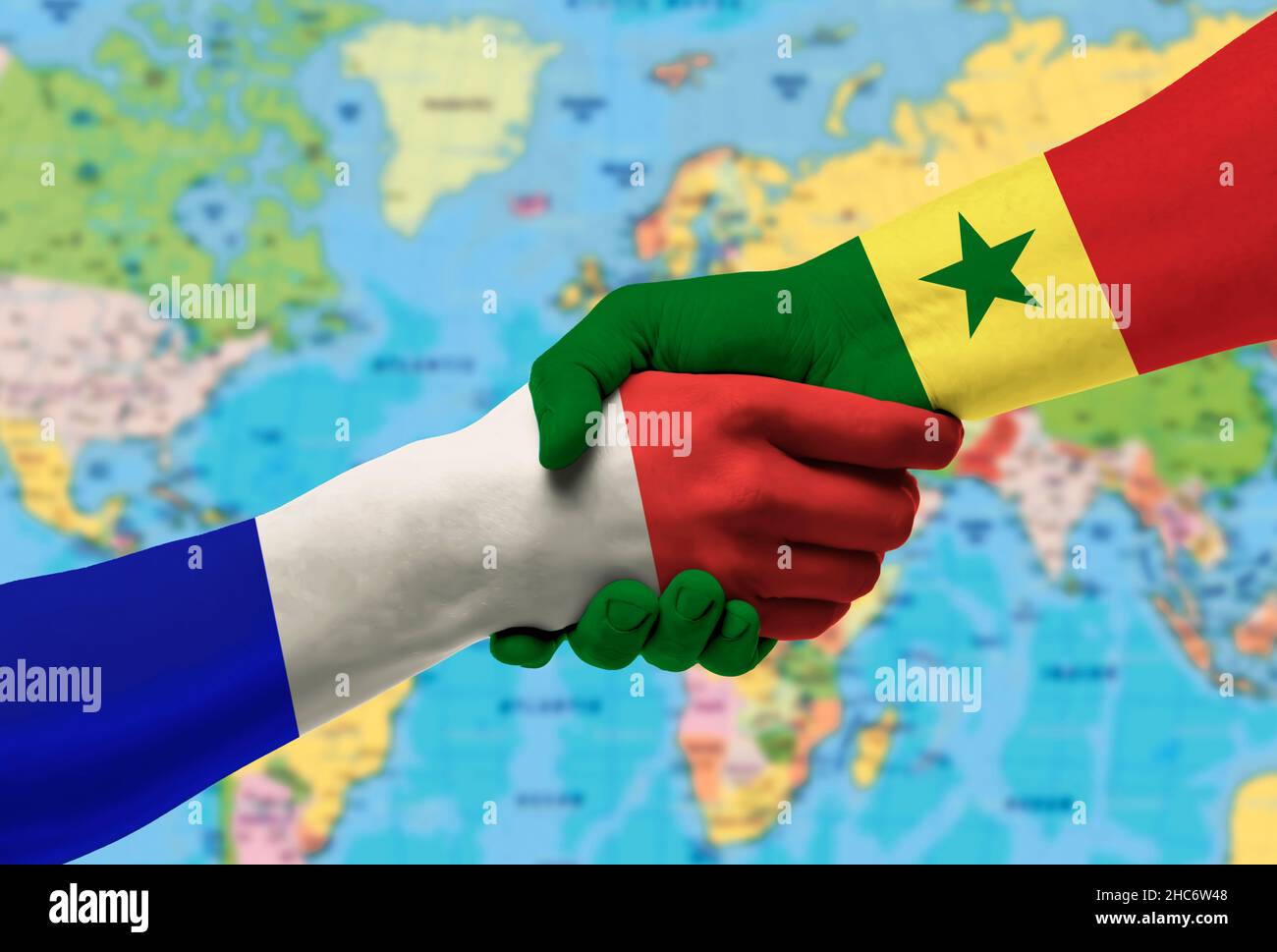 Handshake between Senegal and France flags painted on hands.With ...