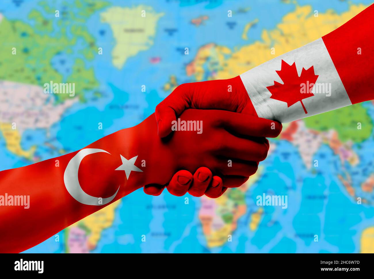 Handshake between Canada and Turkey flags painted on hands.With ...