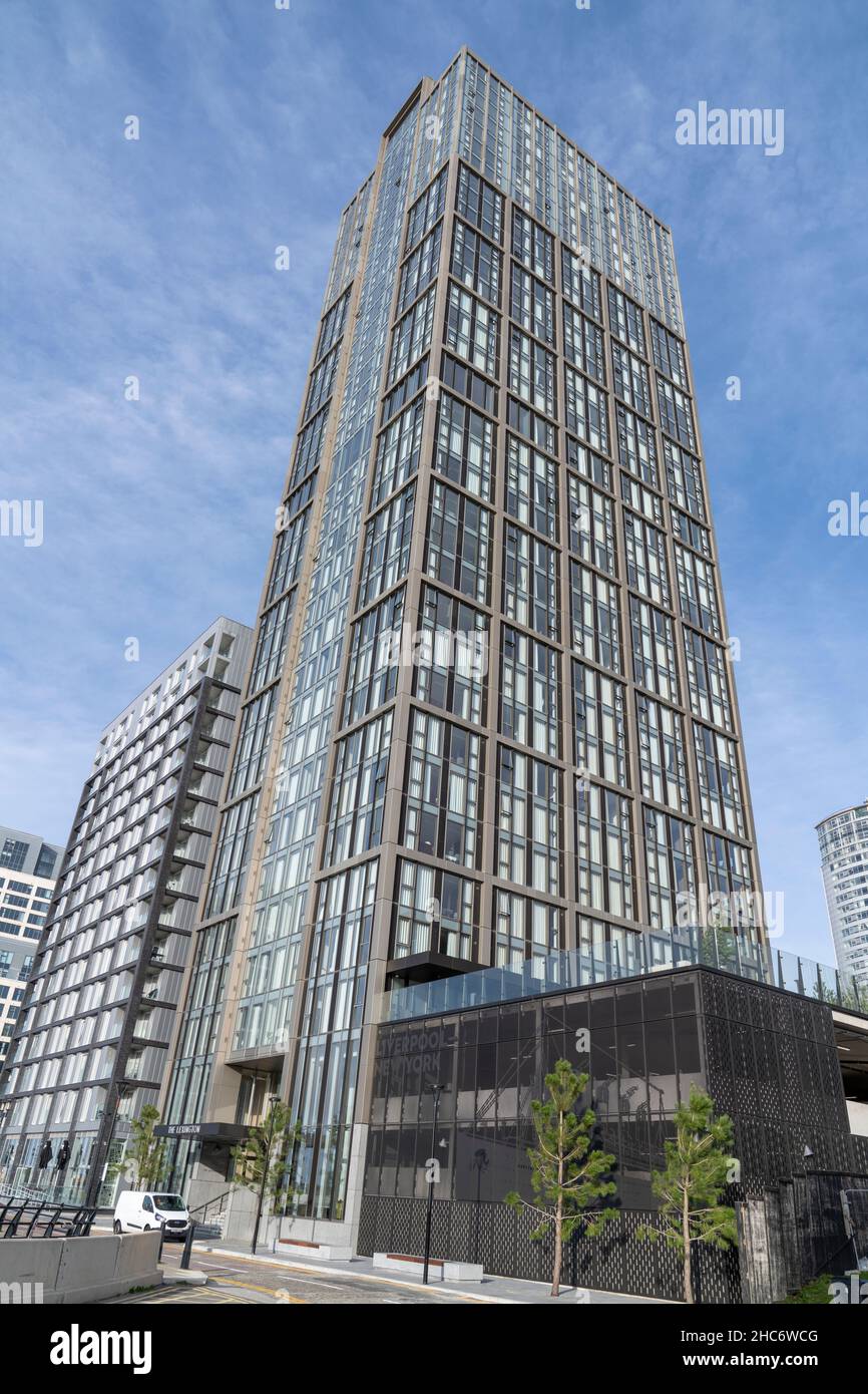 Vertical low angle of a tall modern architecture building in the center ...