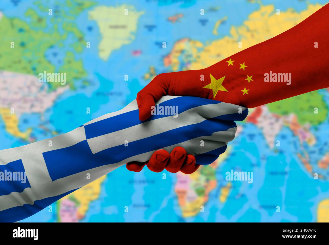 Handshake between Greece and China flags painted on hands.With ...
