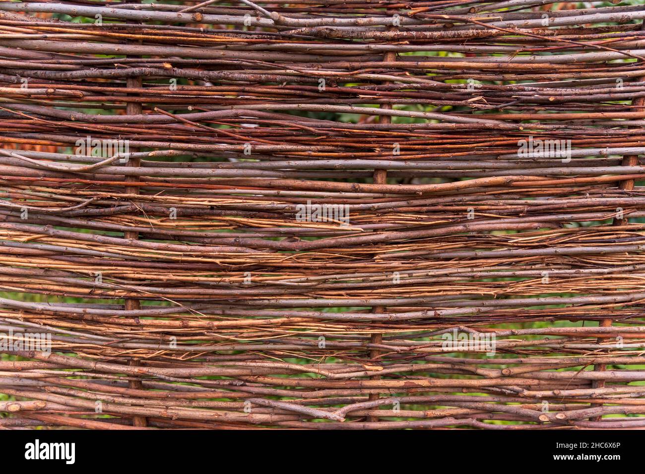 Fence made of wooden rods. Wicker fence made of twigs. Background ...