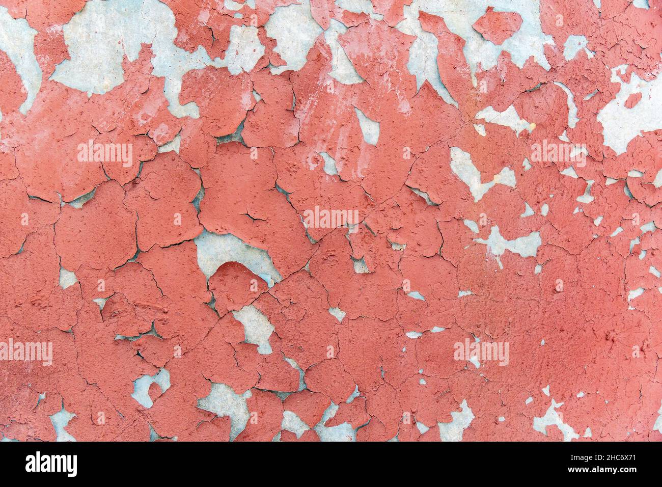 Old concrete wall with red cracked paint texture. Stains on the rough ...