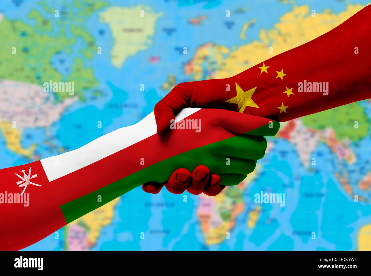 Handshake between China and Oman flags painted on hands.With background ...