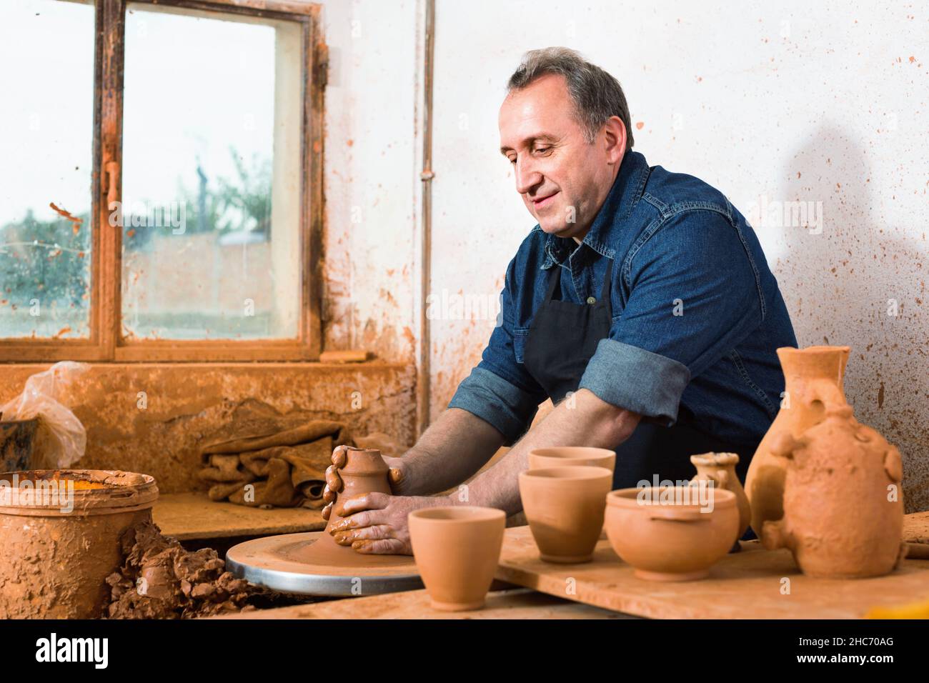 Elderly master among the pottery Stock Photo - Alamy